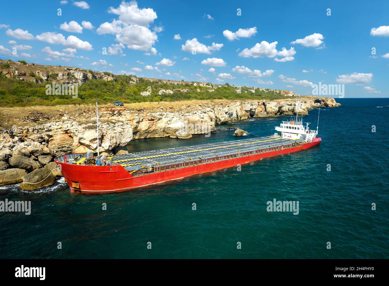 Cargo ship run aground on rocky shore waiting for rescue. Black sea ...