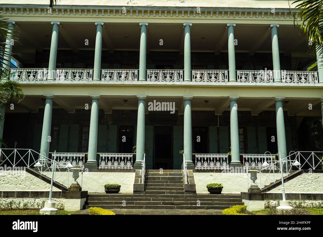 A colonial-style building on a city street in the center of Port Louis ...