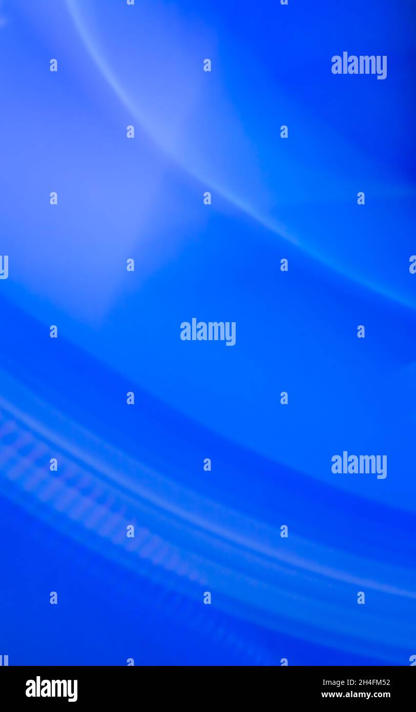 Vertical blue abstract background of curved lines and waves with small ...
