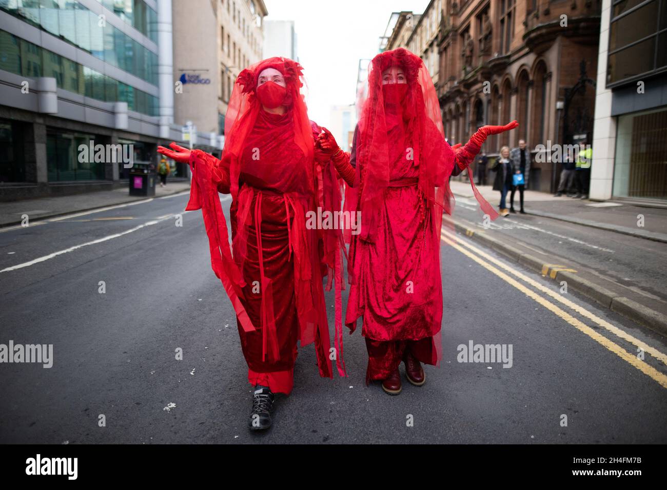 Extinction rebellion (XR) protesters wearing red robes during a protest ...