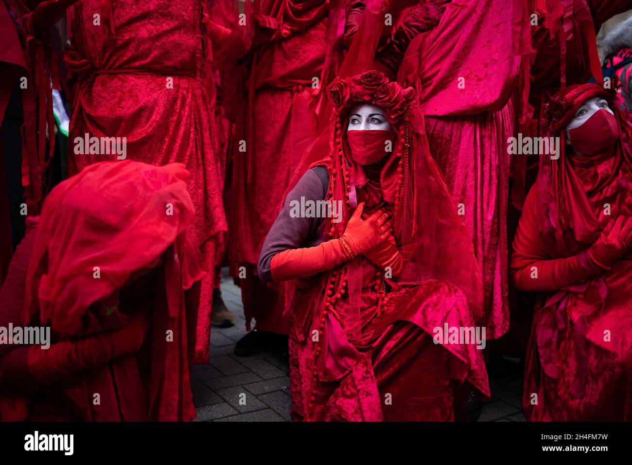 Extinction rebellion (XR) protesters wearing red robes during a protest ...