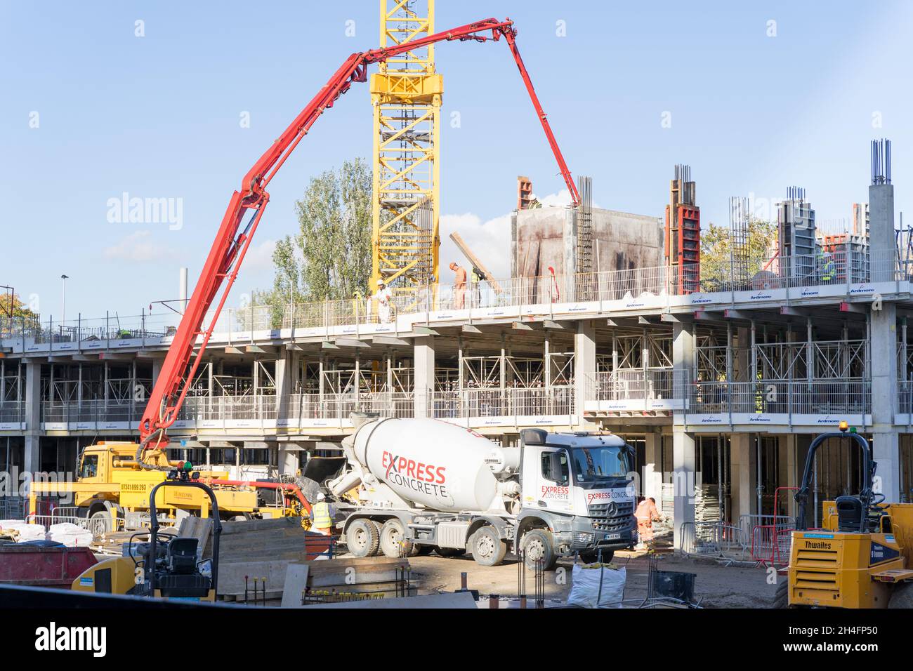 Express concrete truck is feeding the concrete pump for the new floor ...