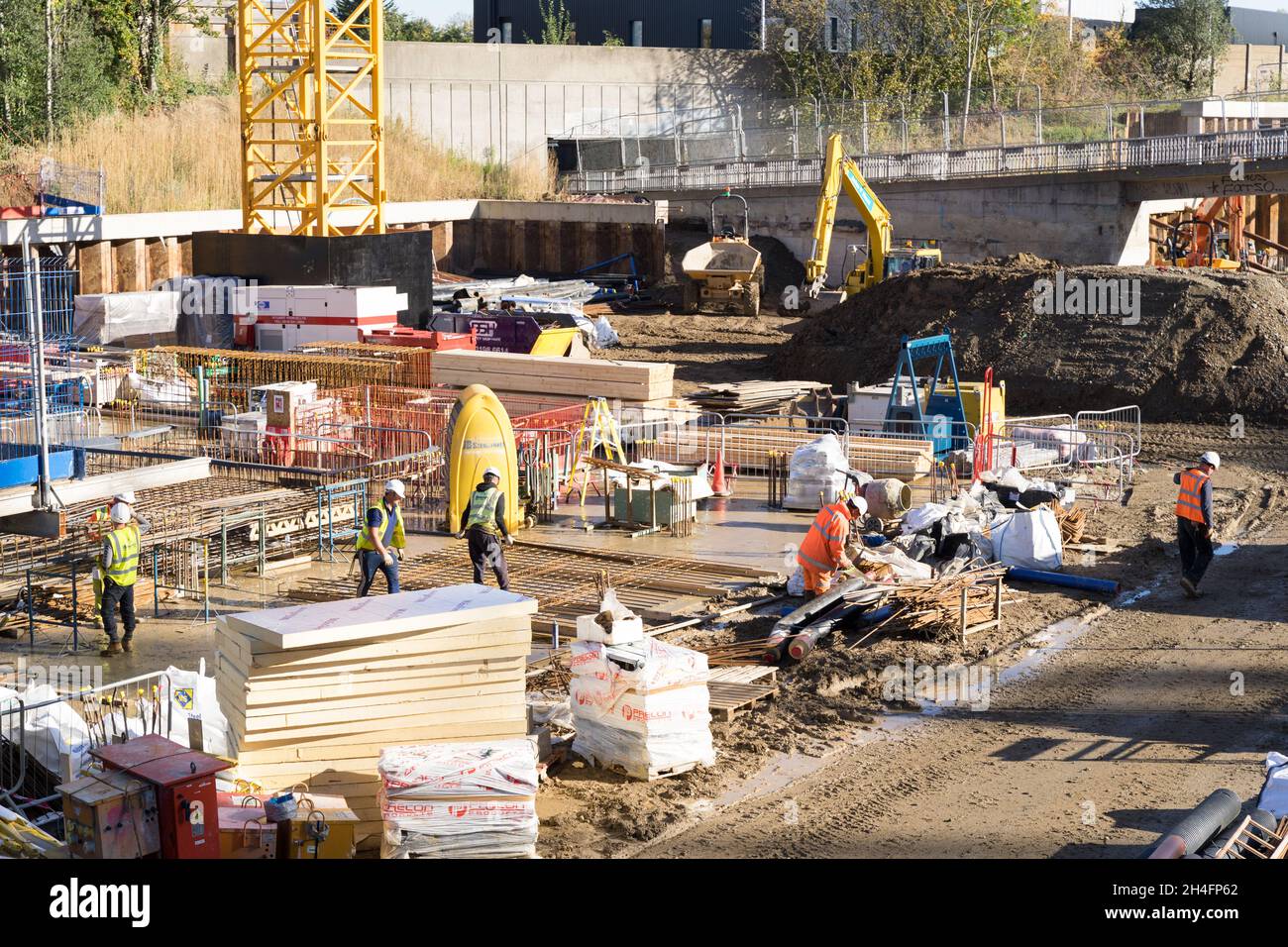 Construction workers working on sunny day at new housing development ...