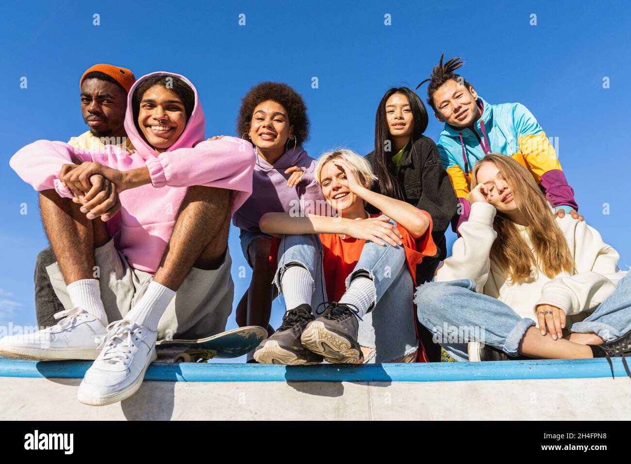 Multicultural group of young friends bonding outdoors and having fun - Stylish cool teens ...