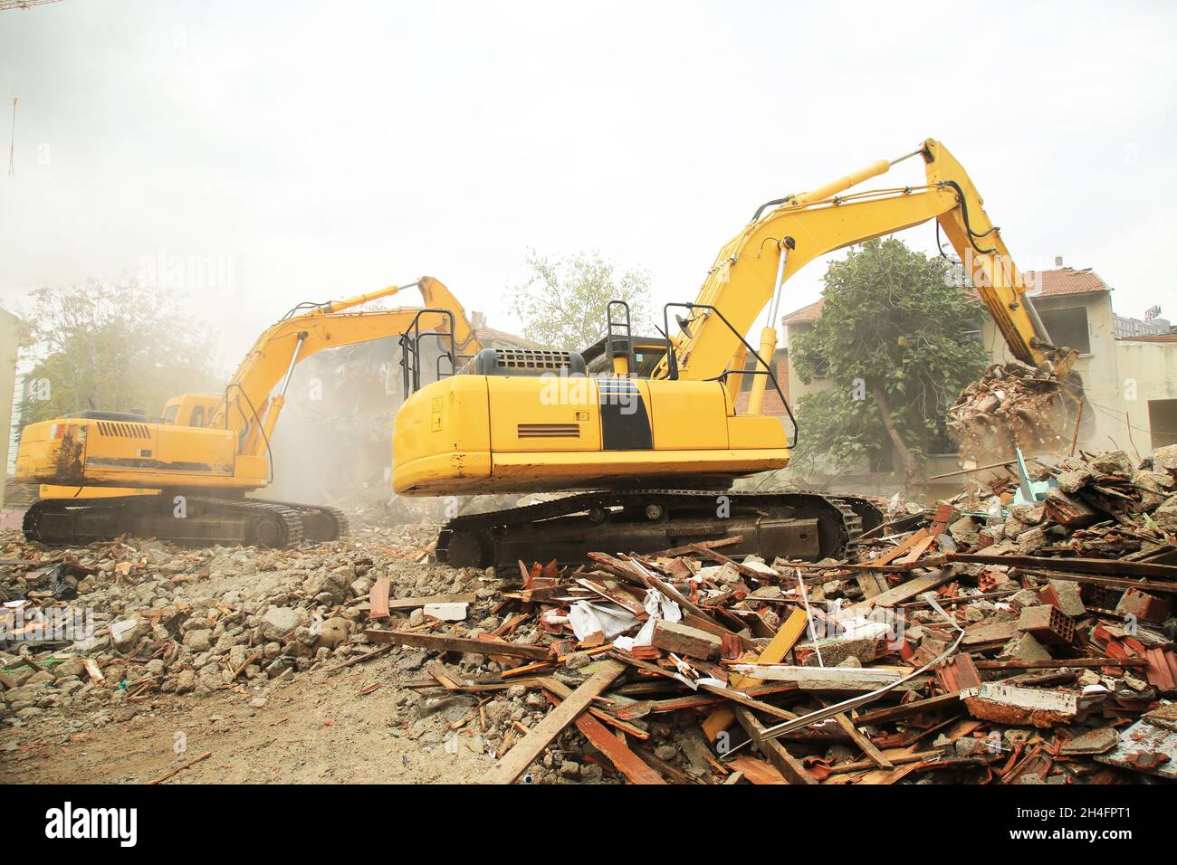 Excavators working on huge demolition site. Construction machinery ...