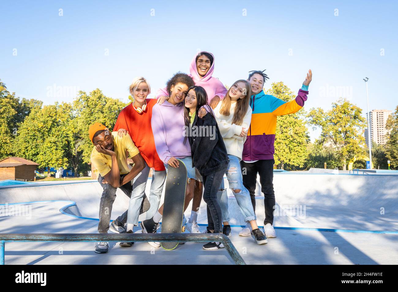Multicultural group of young friends bonding outdoors and having fun ...