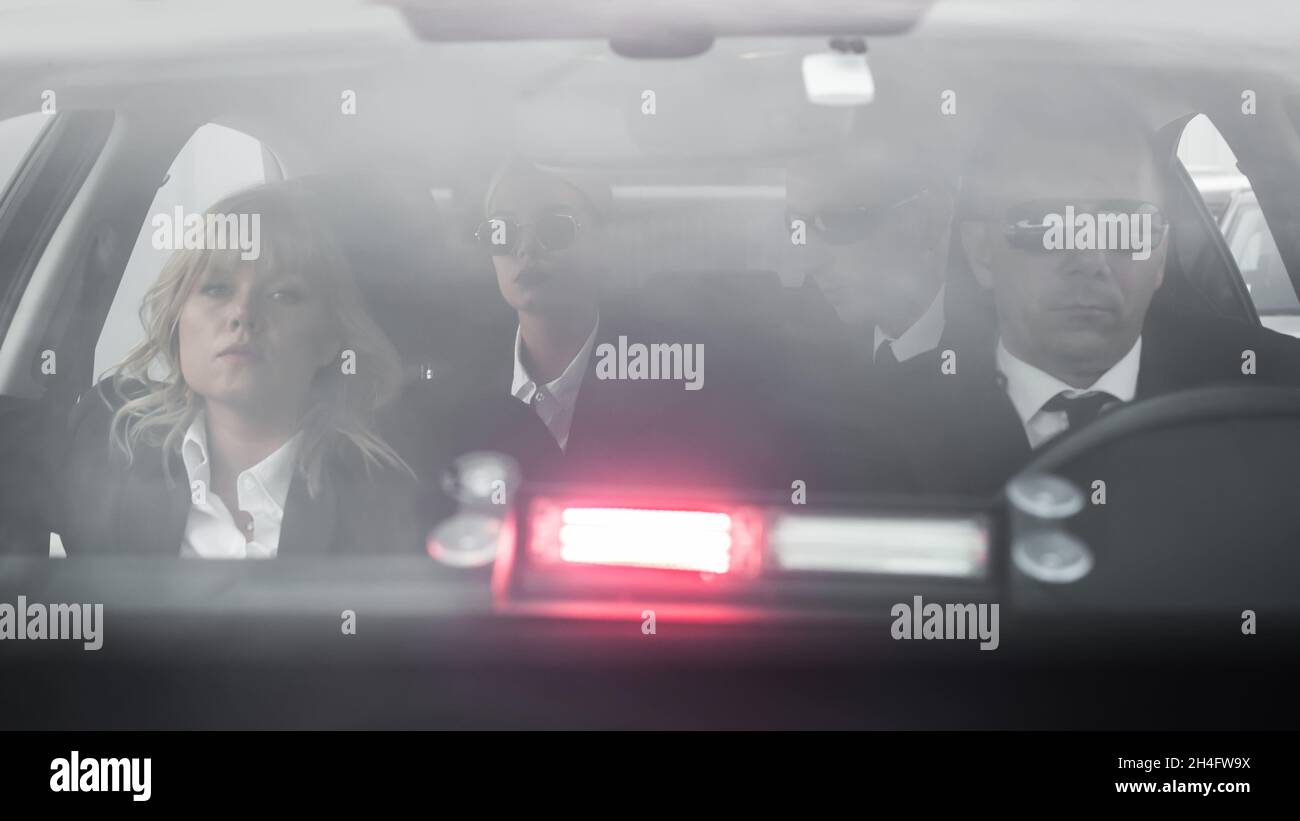 Group of agents protect celebrity vip person in the car limousine with ...