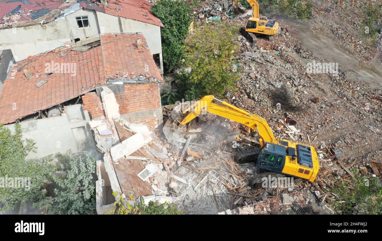 Aerial drone view on excavators demolishing a building. Aerial drone ...
