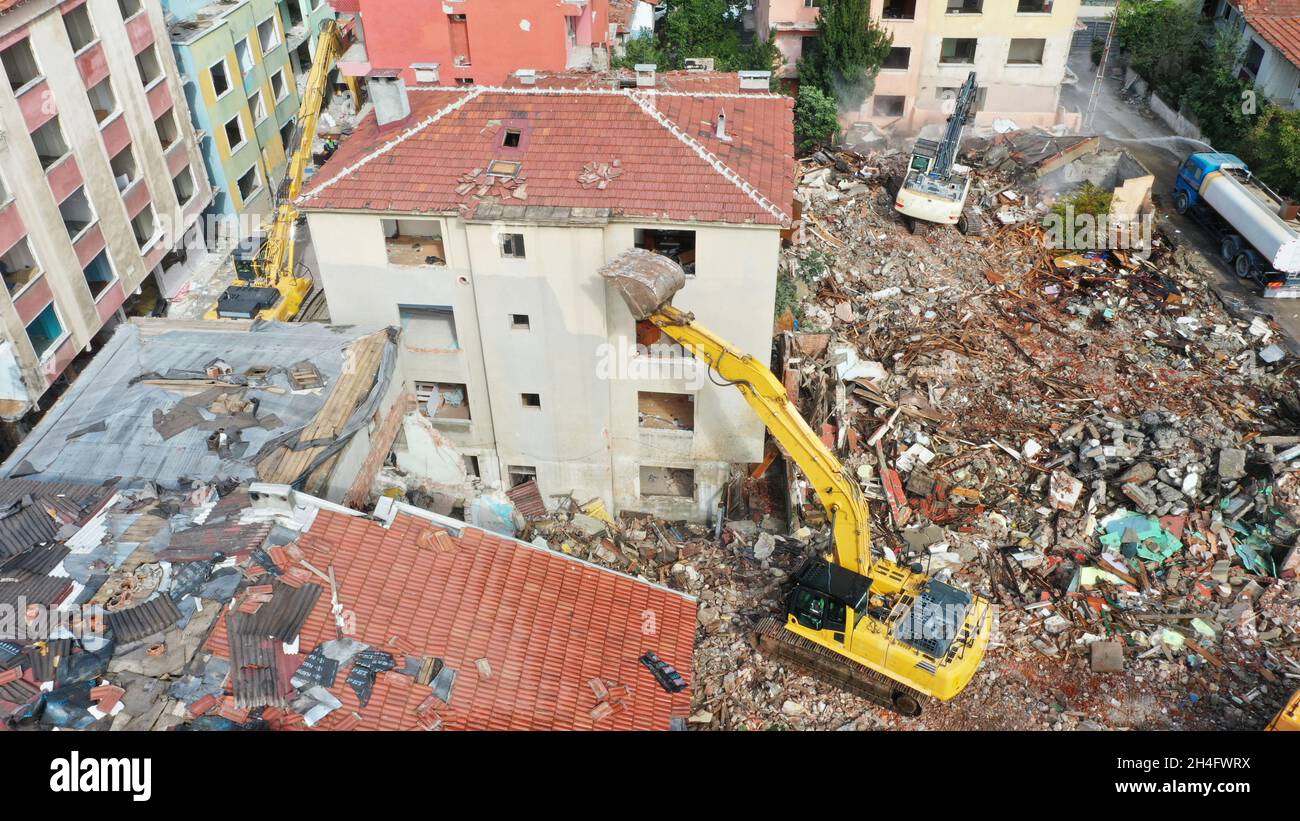 Aerial drone view on excavators demolishing a building. Aerial drone ...