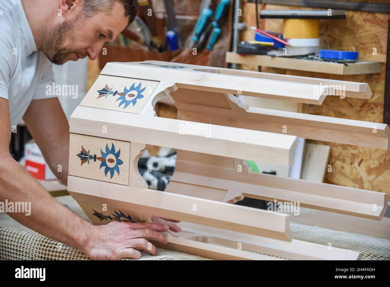Man working as a carpenter making furniture in a woodwork work shop ...