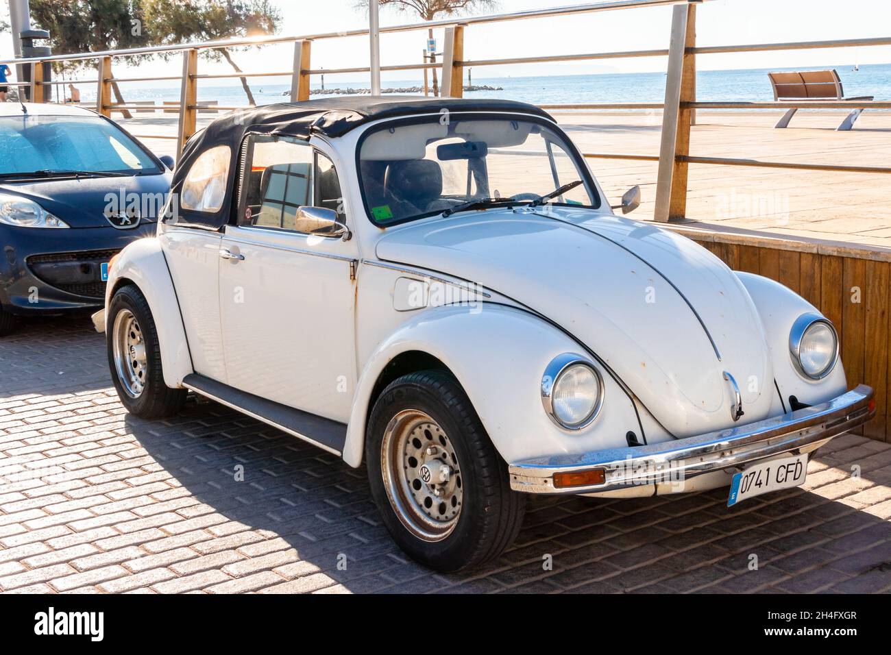 White convertible Type 1 Volkswagen Beetle parked by the sea in Palma ...