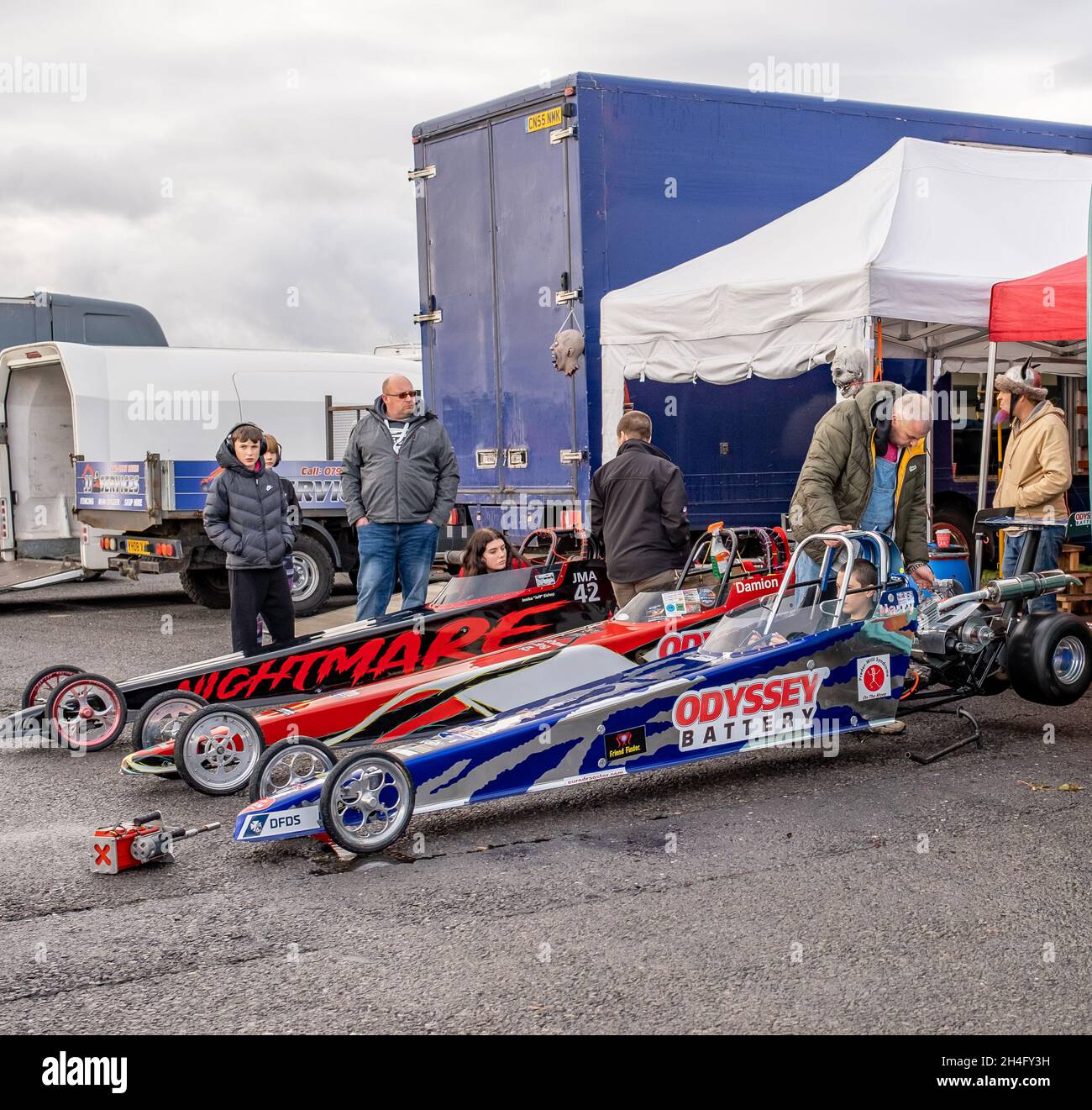 Junior drag racers and respective fathers prepping drag racing cars ...