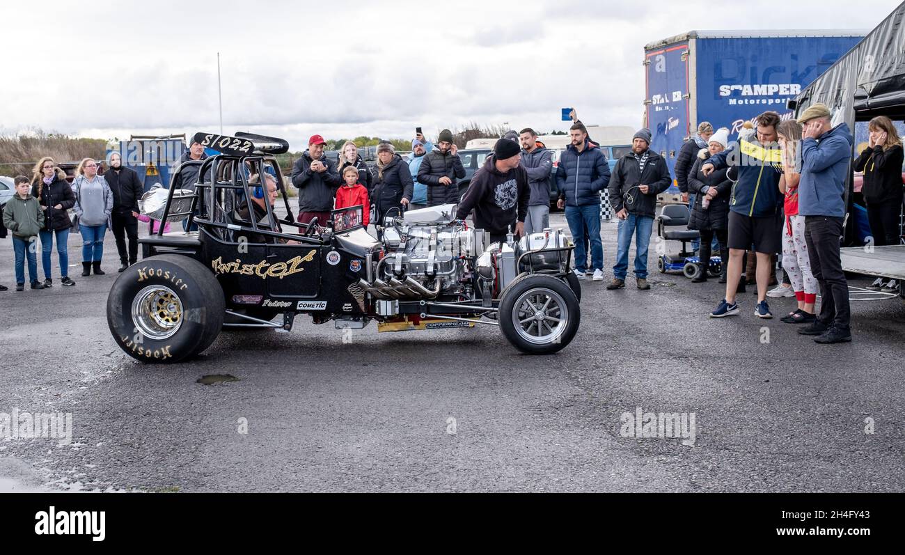 Race goers and spectators gathered around the Twister drag racing car ...