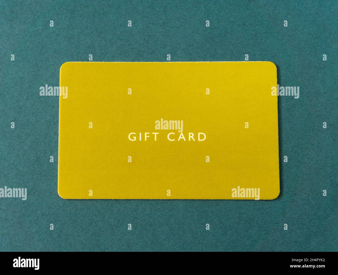 Gift card on green background. yellow gift card Stock Photo - Alamy
