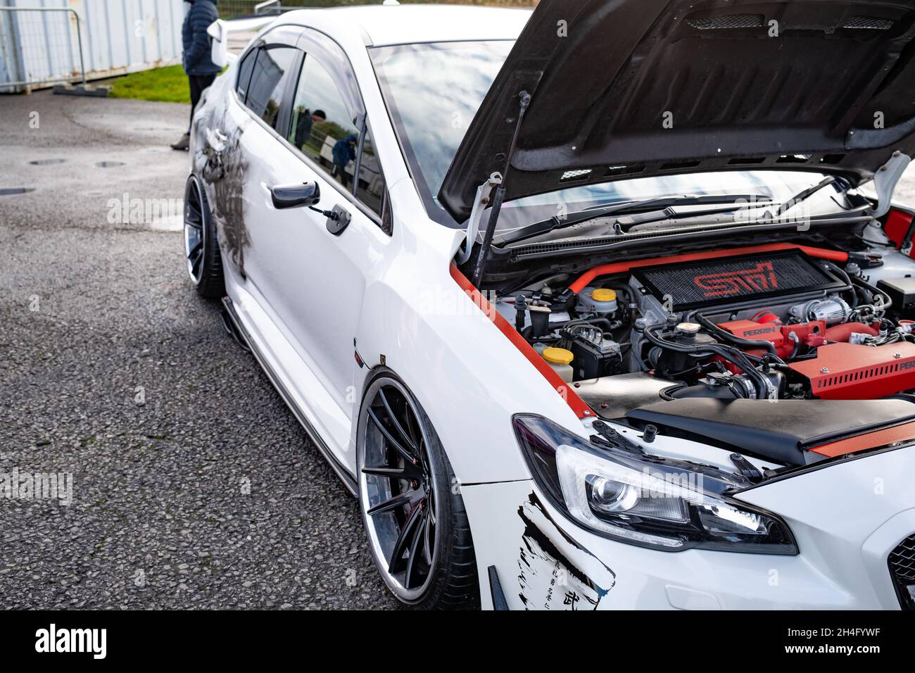 Customised sports car with its bonnet up so the engine can be seen on ...