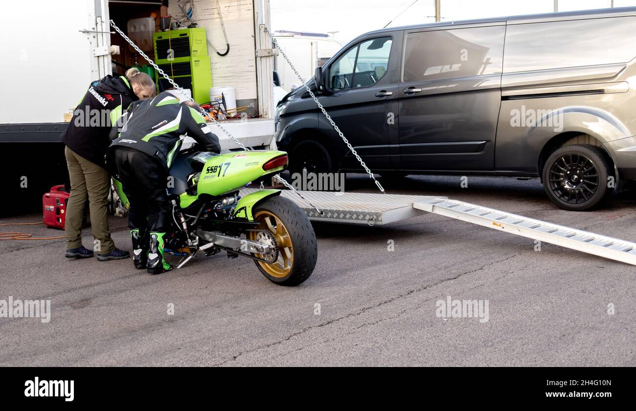 Husband and wife team working on their drag racing motorcycle in the ...