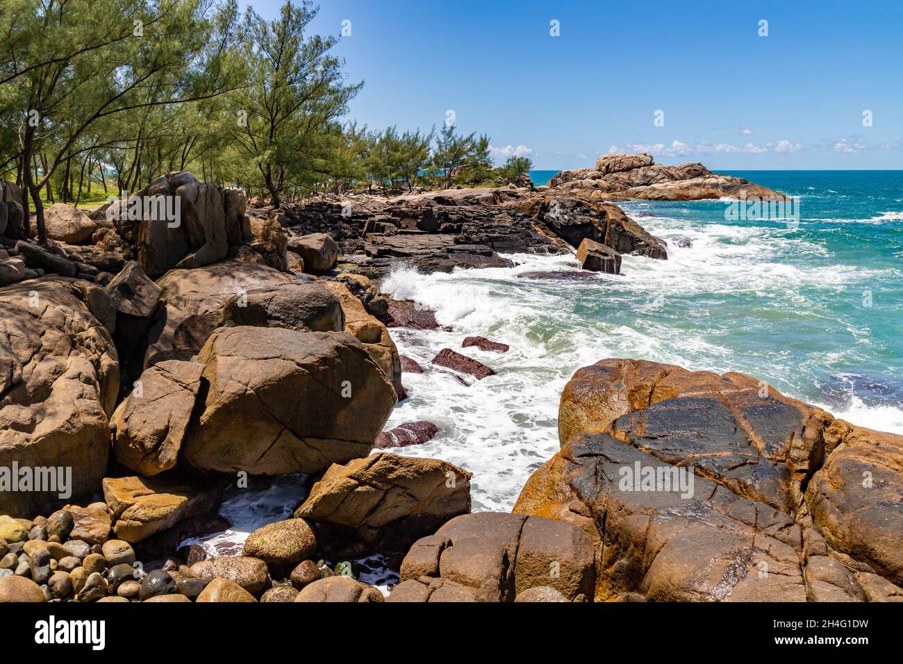 Cliff rocks with vegetation and waves, Praia da Barra, Garopaba, Santa ...