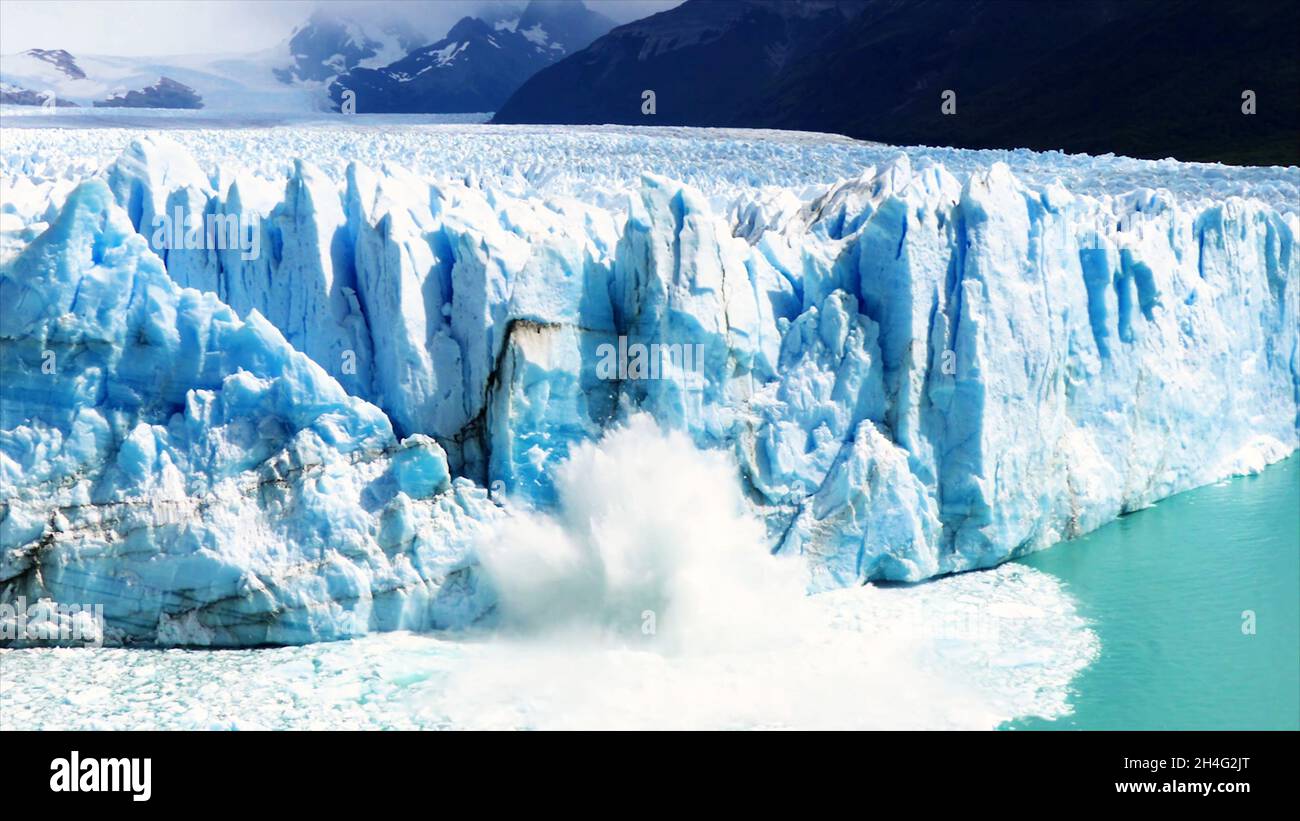 drone view of a huge chunk of glacier ice collapsing and falling into ...