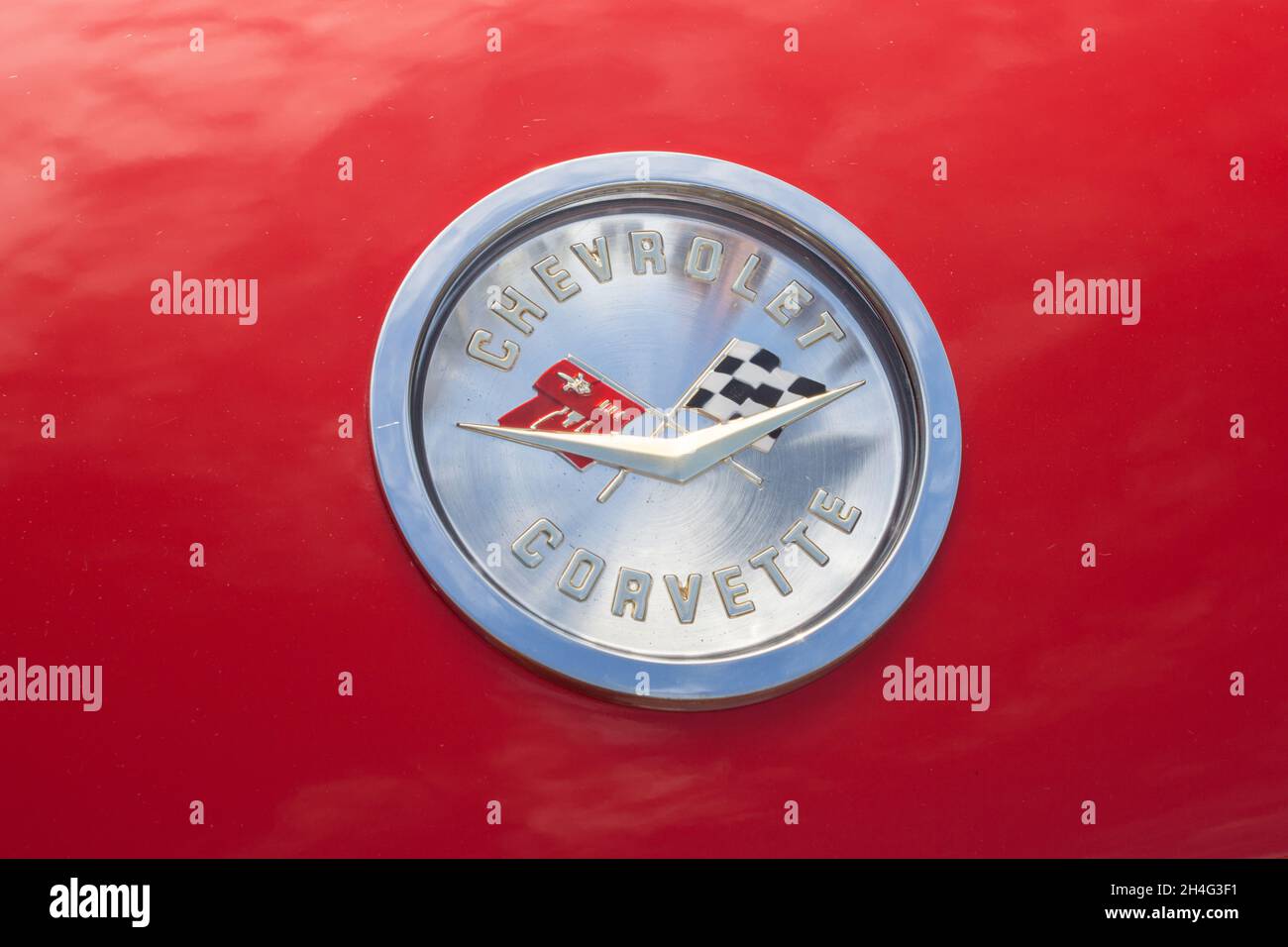 Close up detail of the logo emblem badge on the bonnet of a red ...