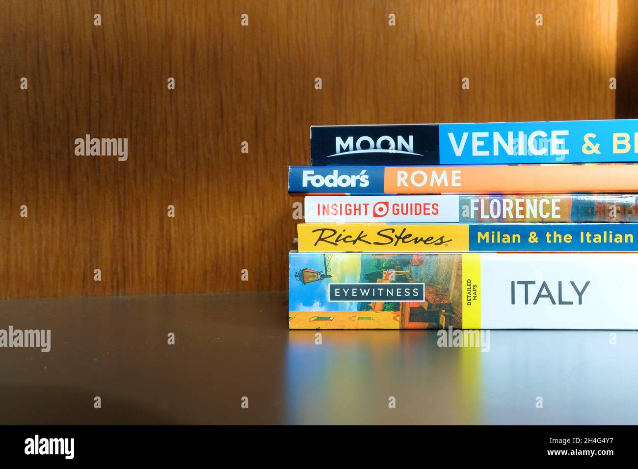 Stacked assorted travel guide books for Italy, Venice, Rome, Florence ...