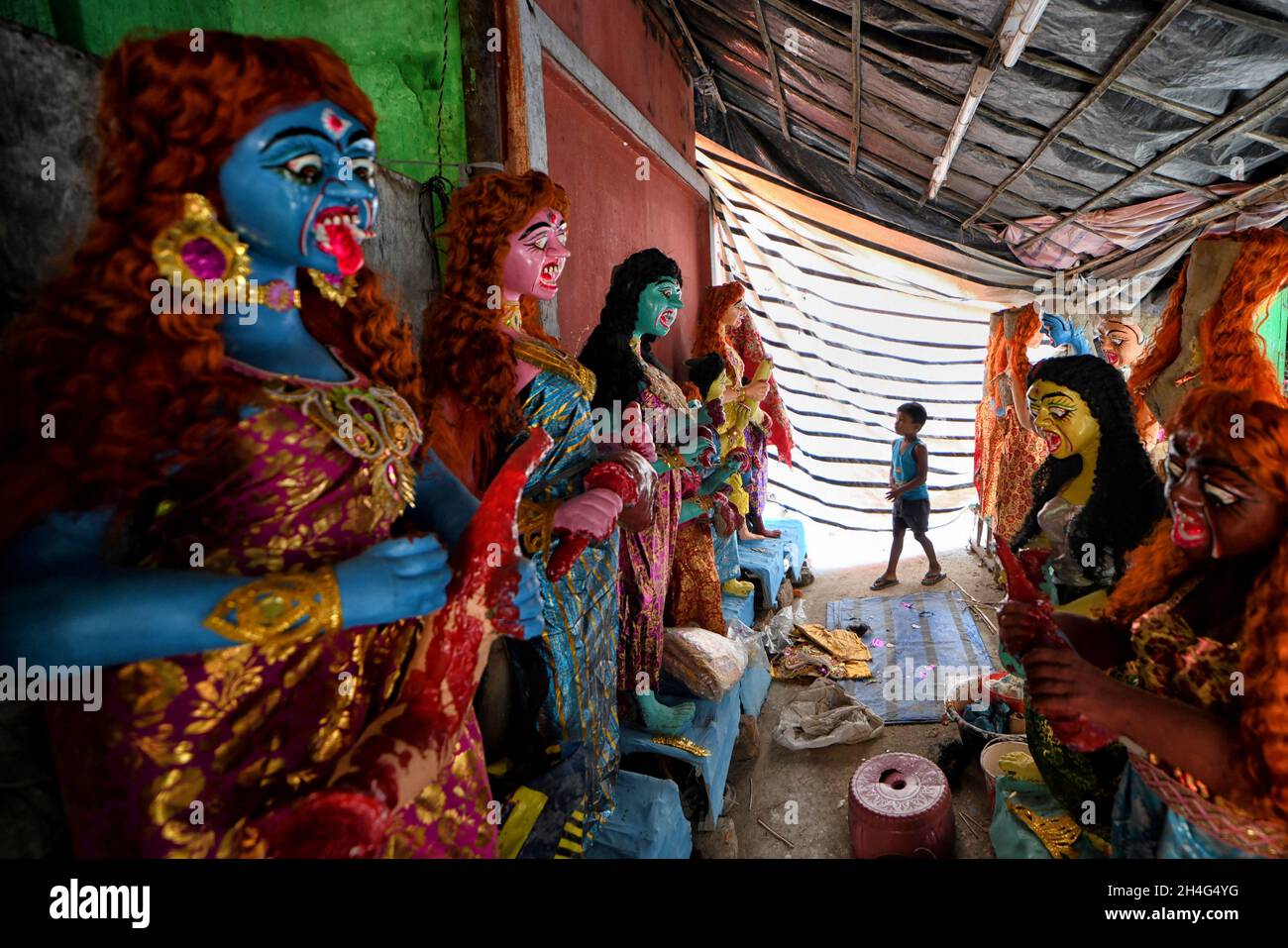 Kolkata, India. 02nd Nov, 2021. A child seen watching the clay demon ...