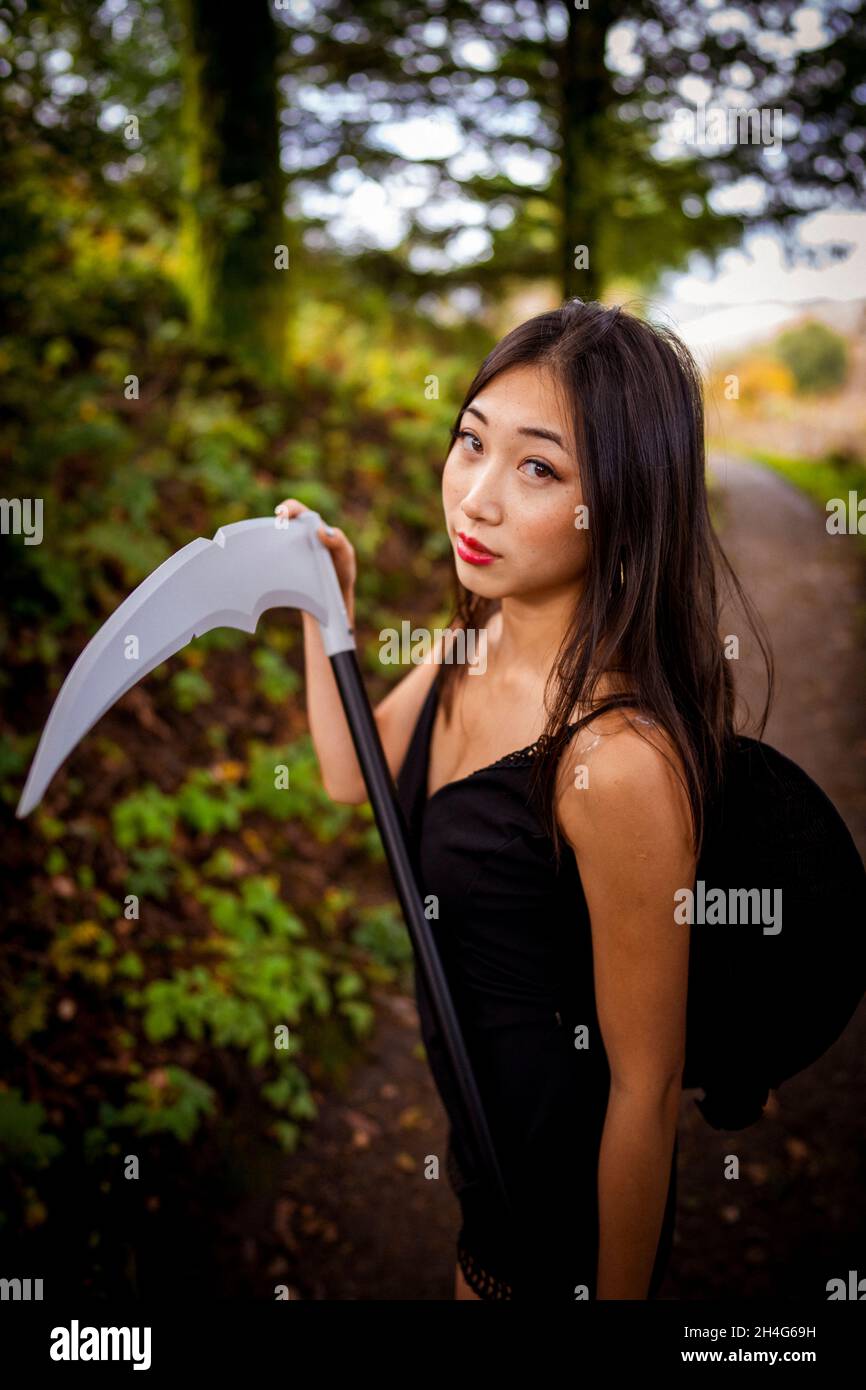 Young Woman Wearing a Grim Reaper Cosplay Outfit in the Woods Stock ...
