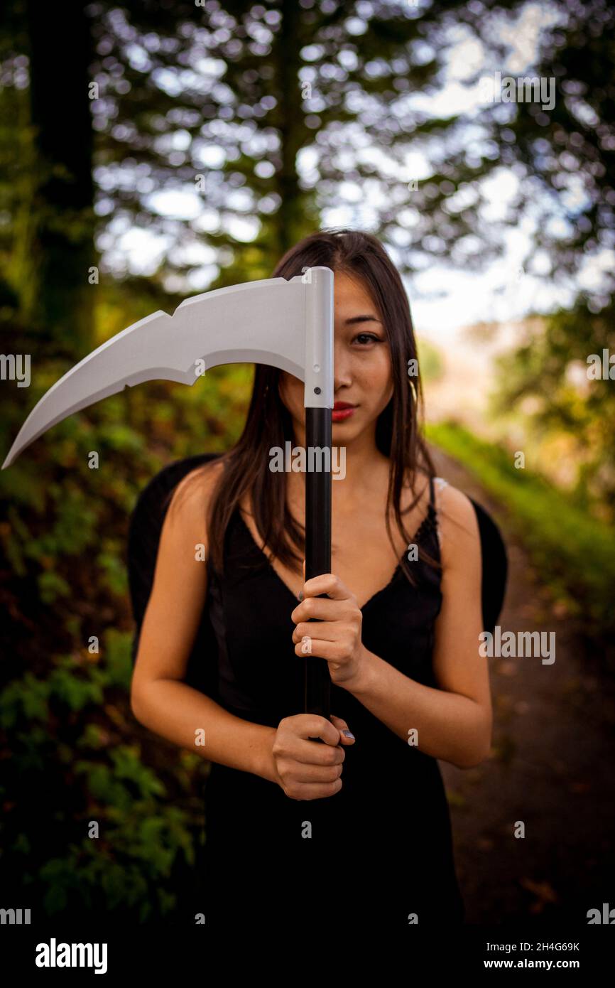Young Woman Wearing a Grim Reaper Cosplay Outfit in the Woods Stock ...