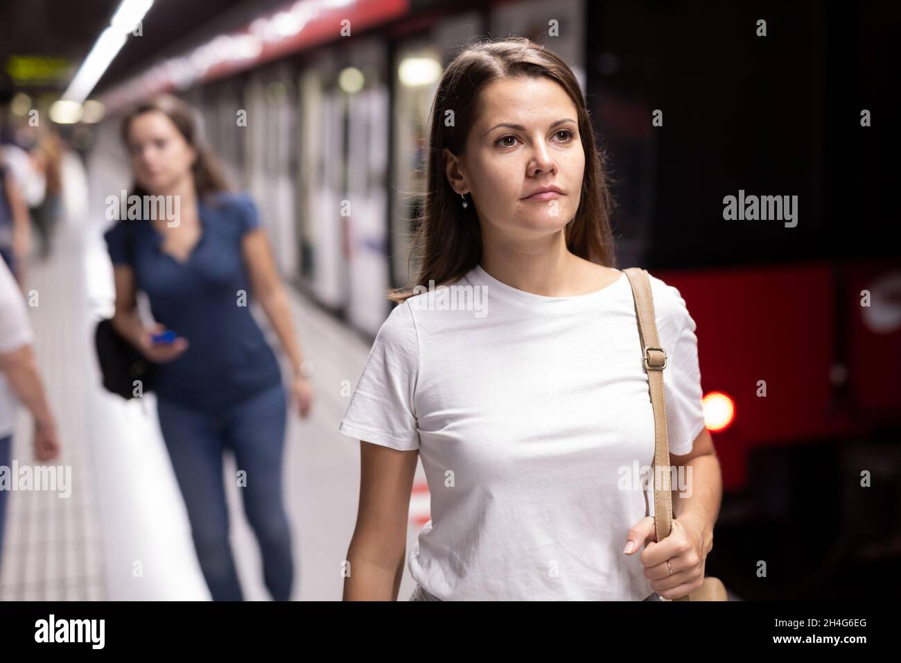 Pretty woman walks on the subway platform Stock Photo - Alamy