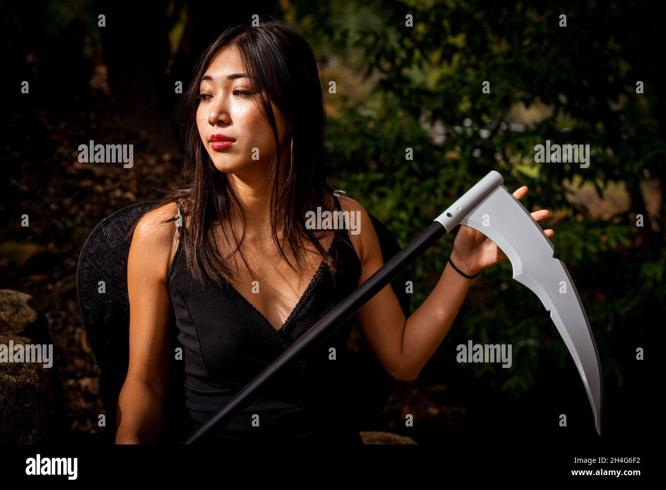 Young Woman Wearing a Grim Reaper Cosplay Outfit in the Woods Stock ...