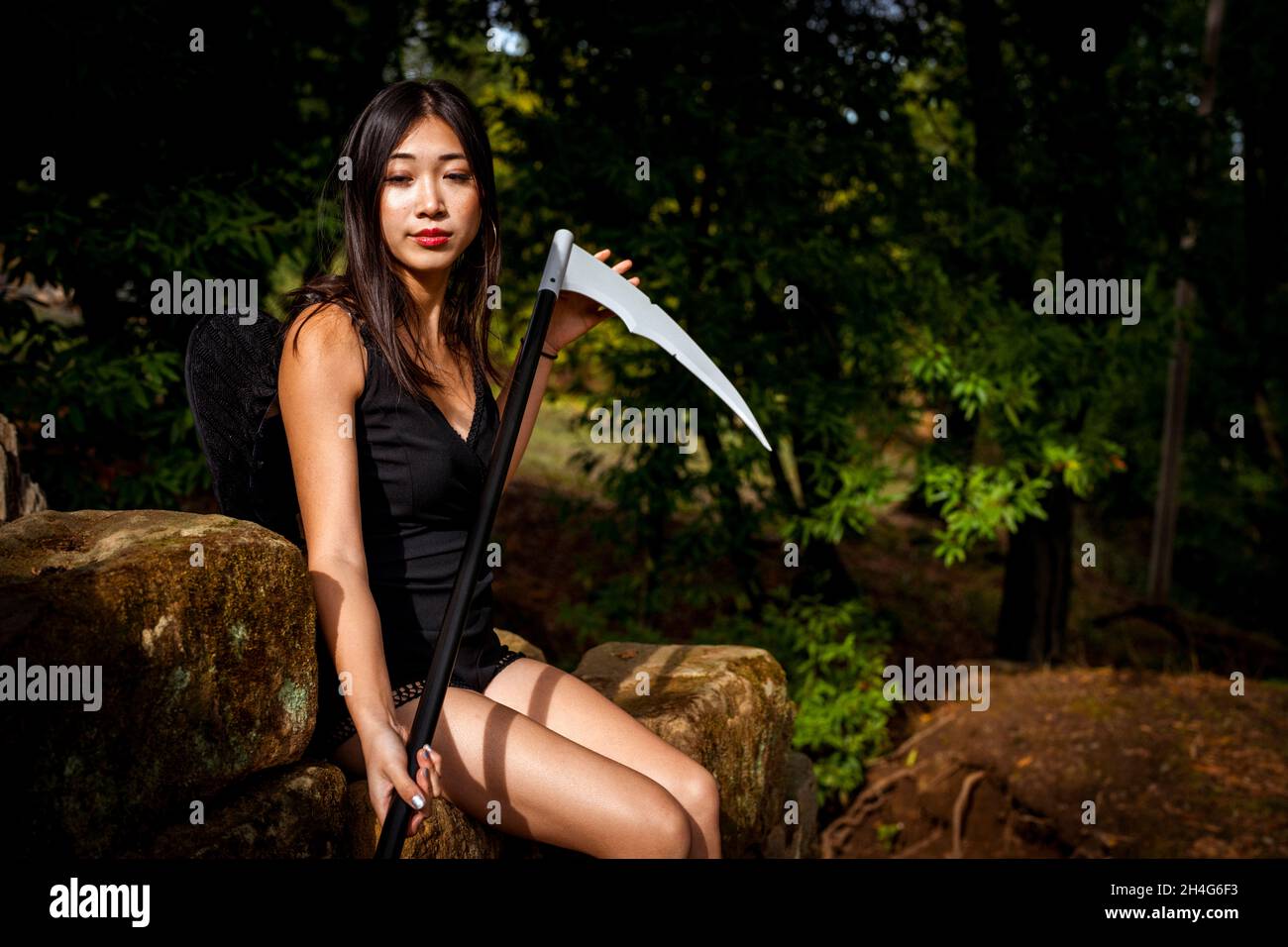 Young Woman Wearing a Grim Reaper Cosplay Outfit in the Woods Stock ...