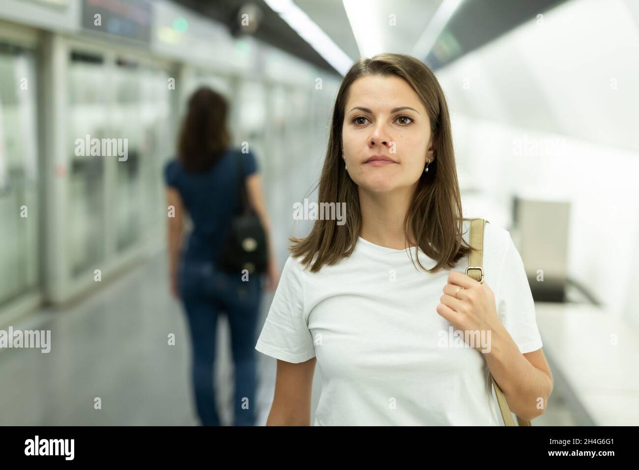 Pretty woman walks on the subway platform Stock Photo - Alamy