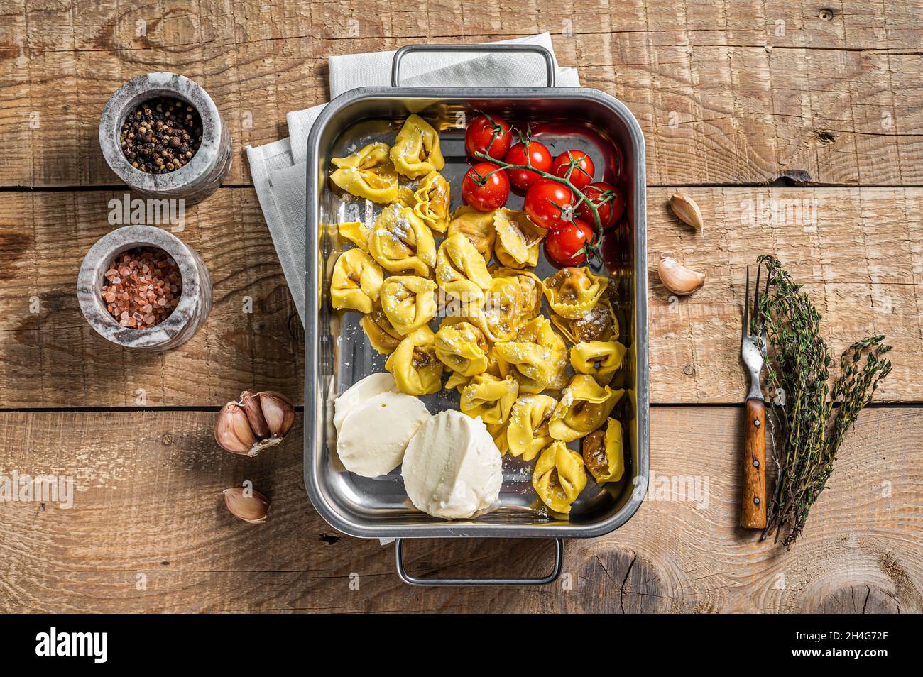 Homemade raw ravioli with Mozzarella cheese and Tomato in kitchen tray ...