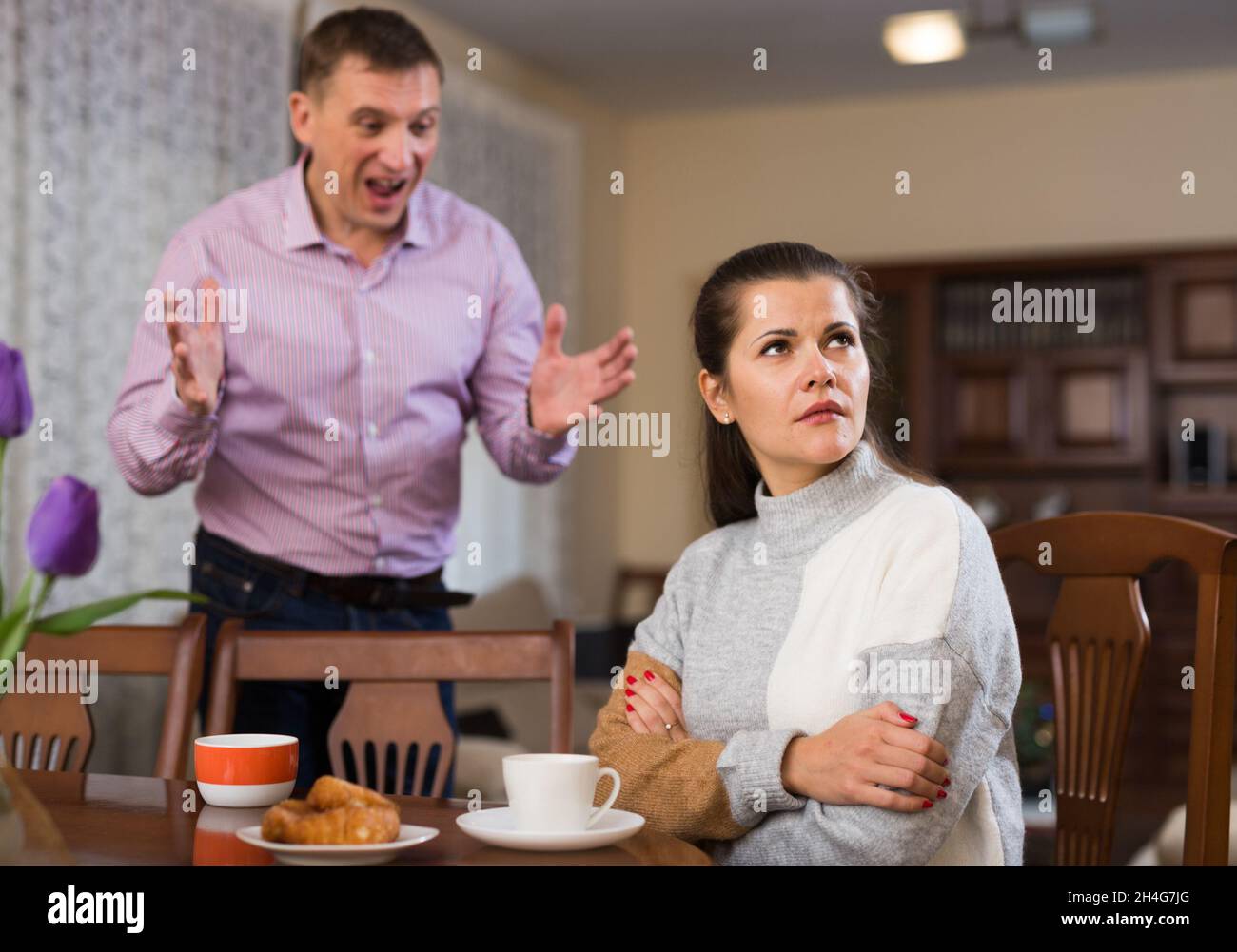 Frustrated woman while man rebuking her Stock Photo - Alamy