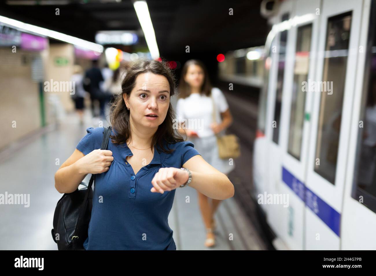 Hurrying woman is late for subway train Stock Photo - Alamy