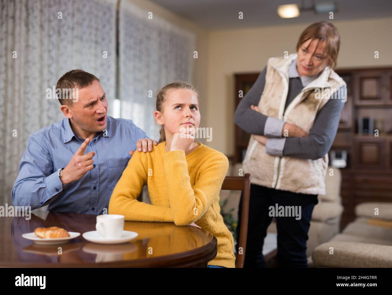 Woman and man lecturing teenage girl Stock Photo - Alamy