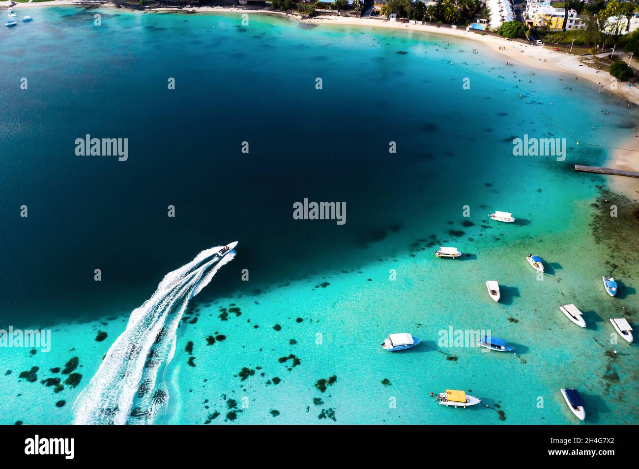 Top view of the Blue Bay lagoon of Mauritius. A boat floats on a ...
