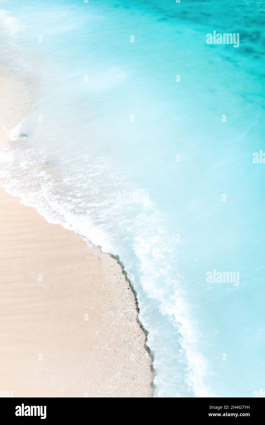 Tropical beach with a bird's eye view of the waves breaking on the ...