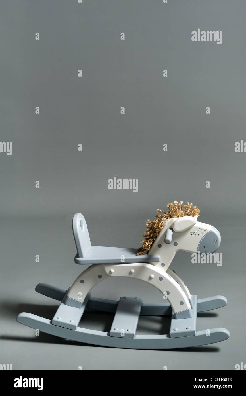 Handmade rocking horse on a gray background Stock Photo - Alamy