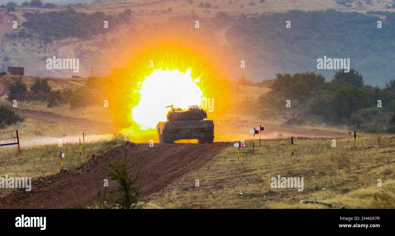 Soldiers with the Hellenic Army fire a 120mm round from a Leopard A2 ...