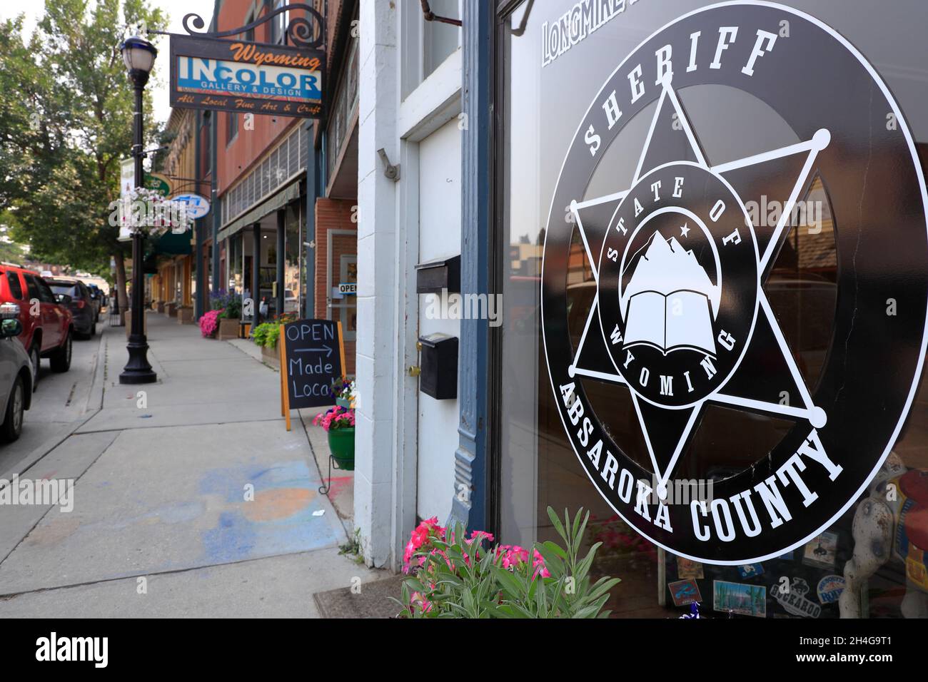 The badge shaped sign logo of Absaroka County Sheriff on window of ...