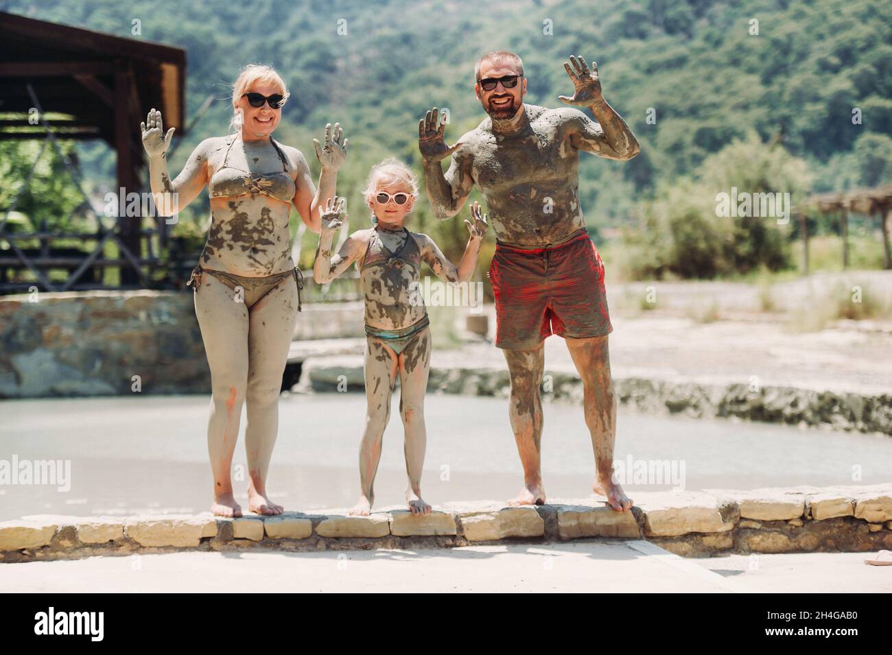 A happy family of three takes mud baths at a resort in Turkey.Family ...