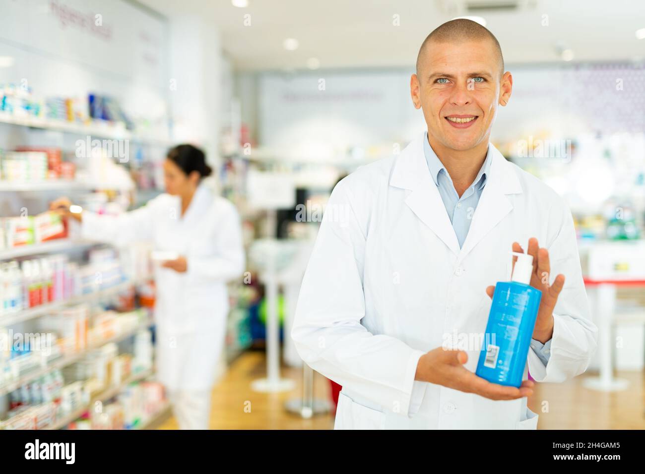 Male pharmacist offers medicine while standing in the trading floor of ...