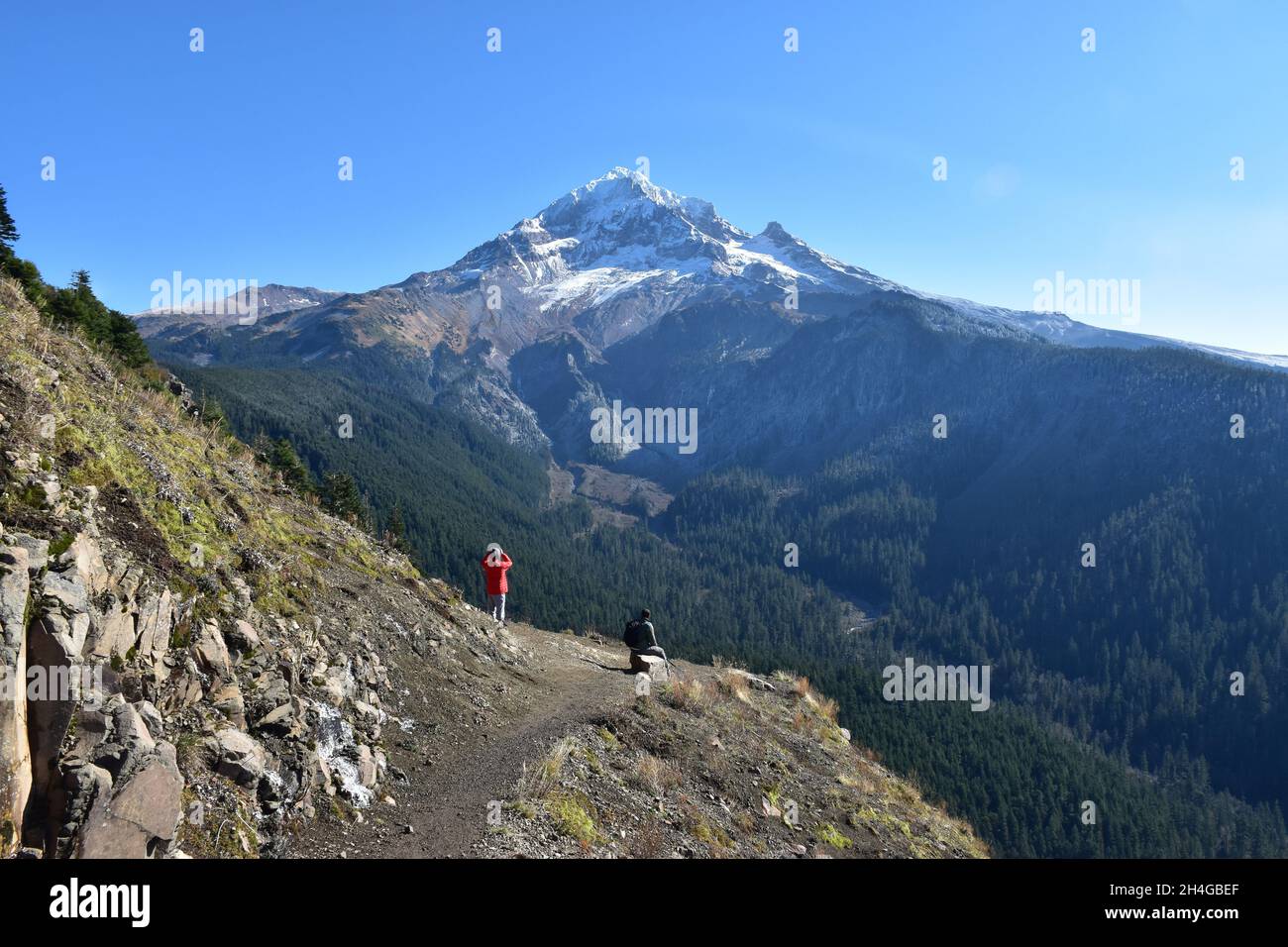 Two hikers enjoy spectacular views of Mt Hood from Bald Mountain on an ...