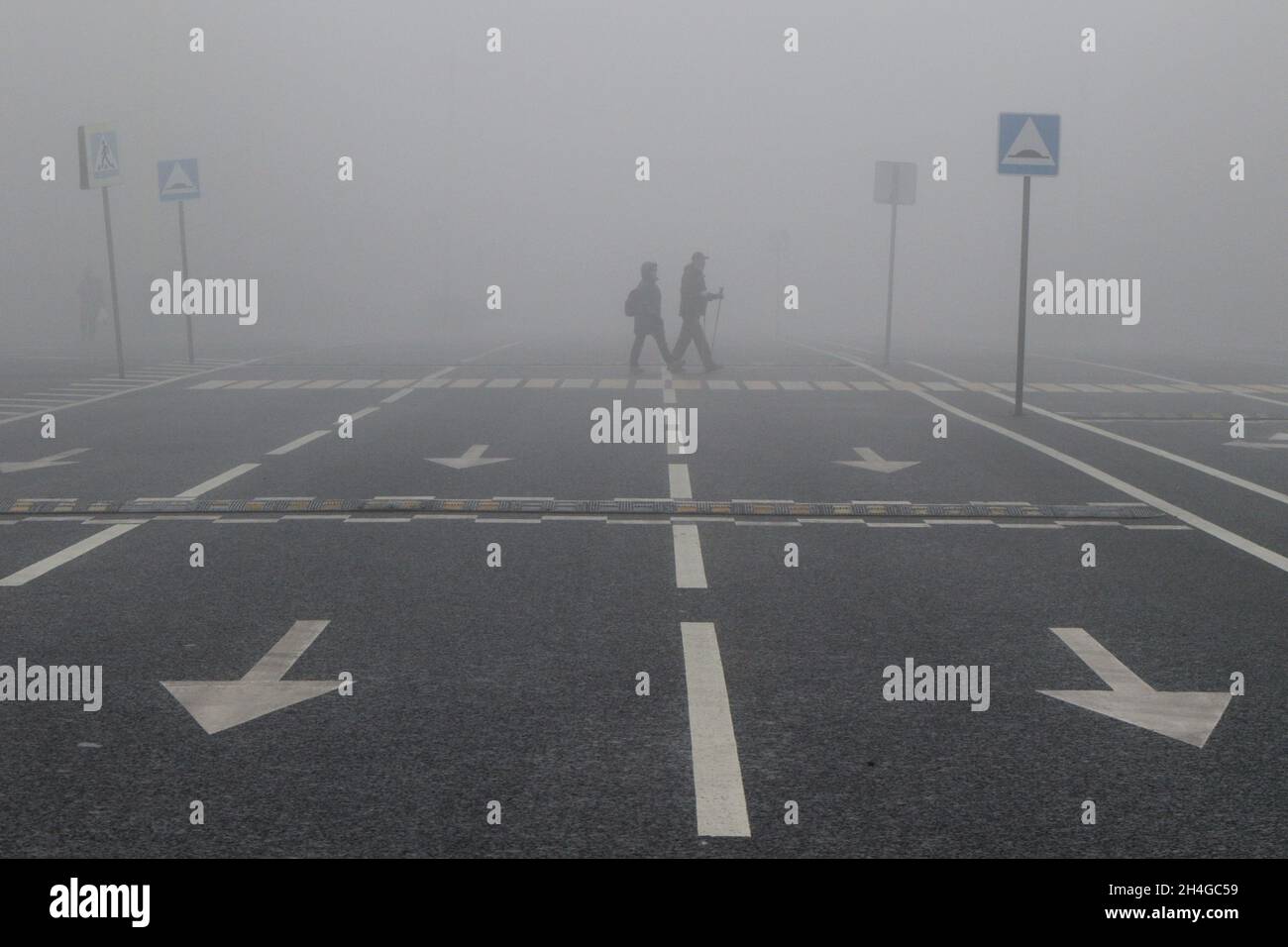 A couple walks across the street near the main entrance of Moscow State ...