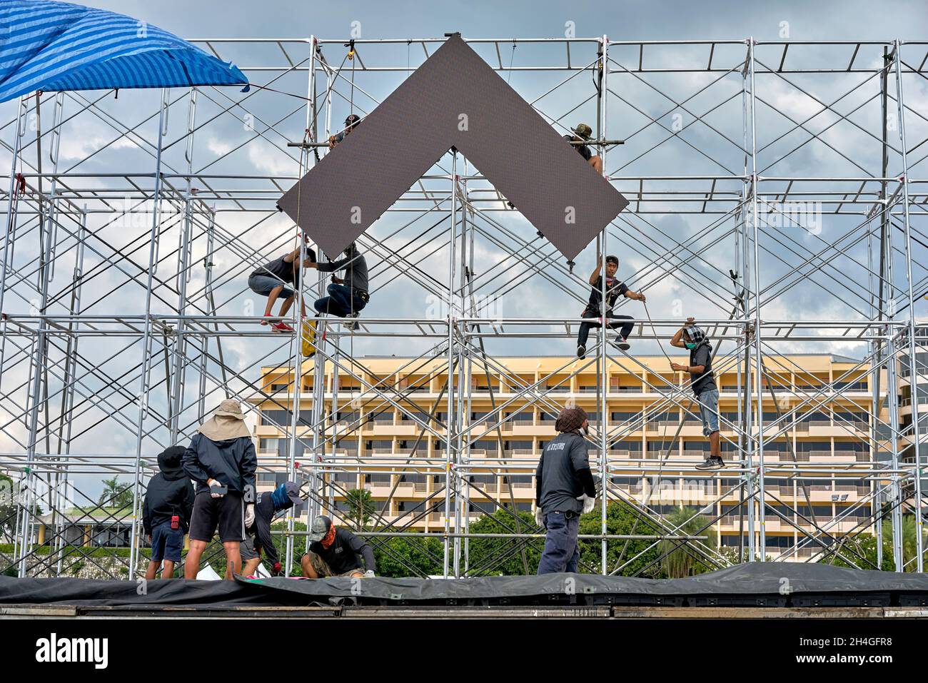 Scaffolders erecting scaffolding in preparation of a stage show ...