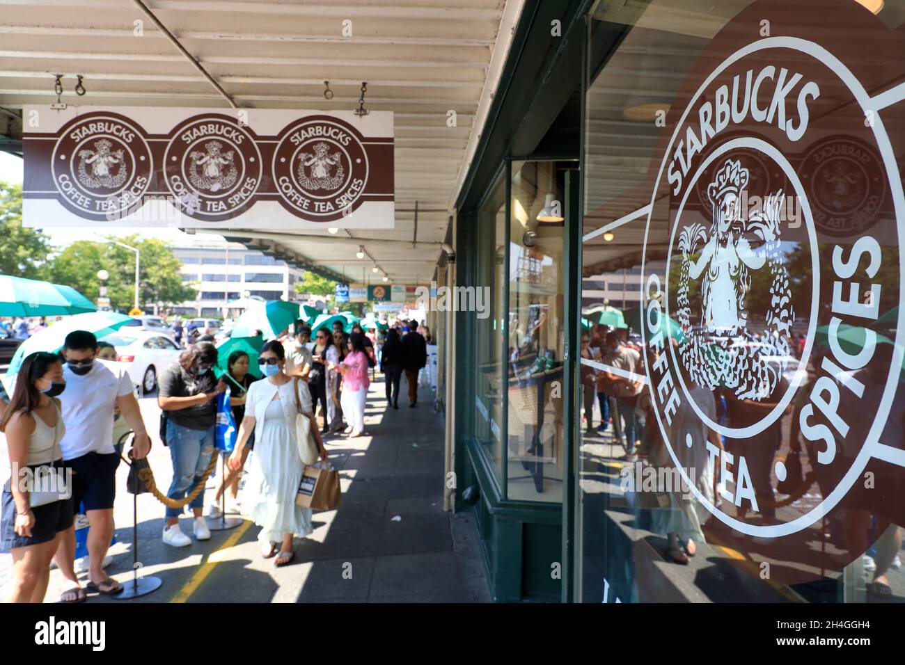 Customers lined up outside of the original Starbucks coffee shop in ...