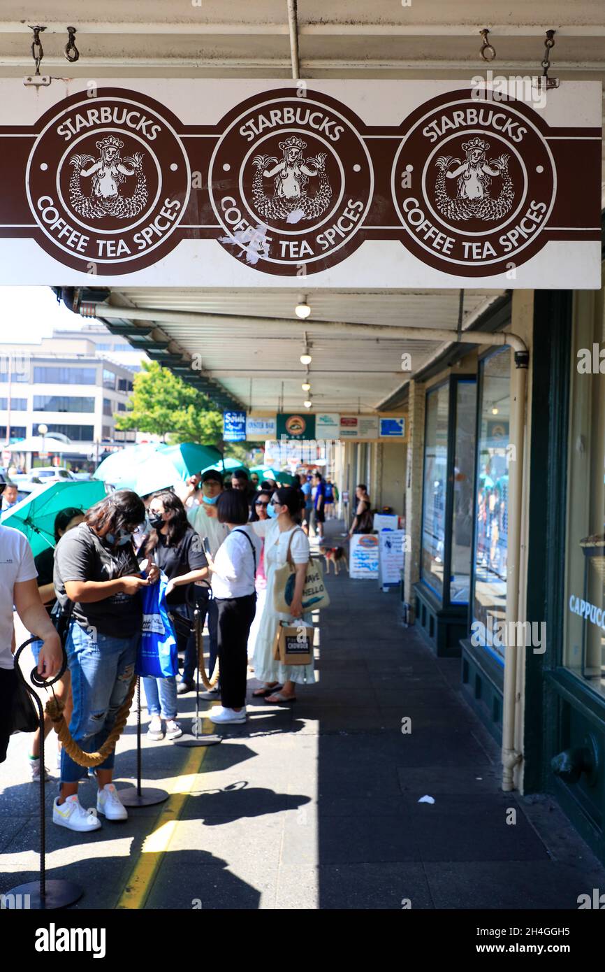 Customers lined up outside of the original Starbucks coffee shop in ...