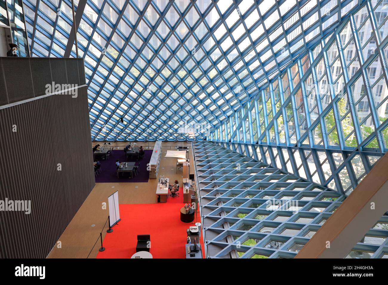 Interior view of Seattle Central Library with sloped glass roof ...
