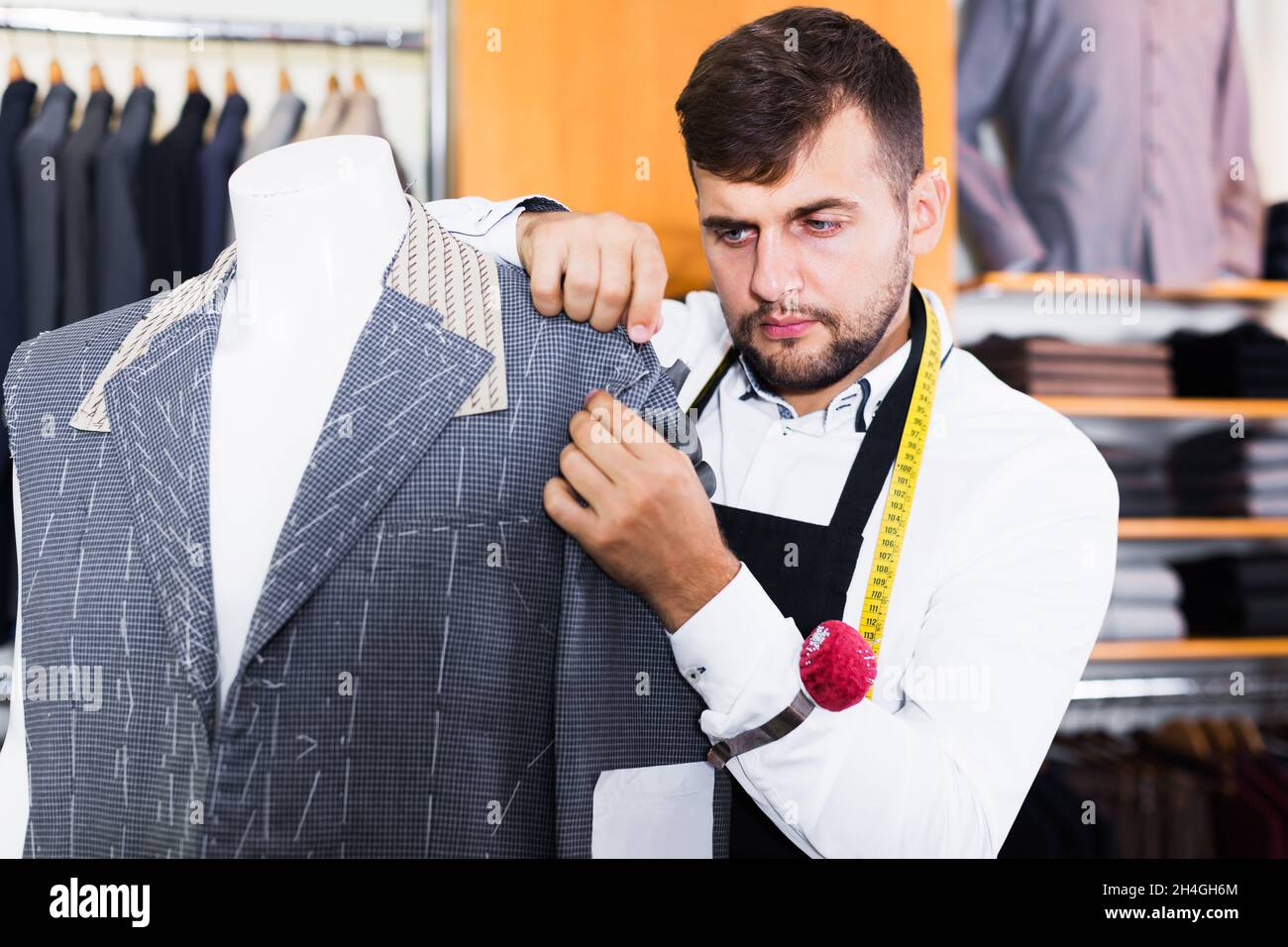Young handsome tailor working hi-res stock photography and images - Alamy