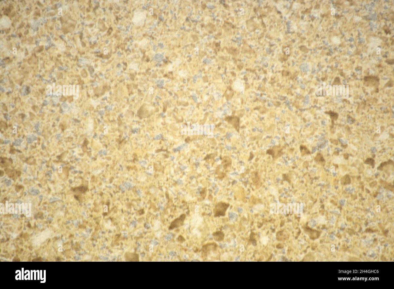 Golden granite, a flat polished surface of a natural stone close-up ...